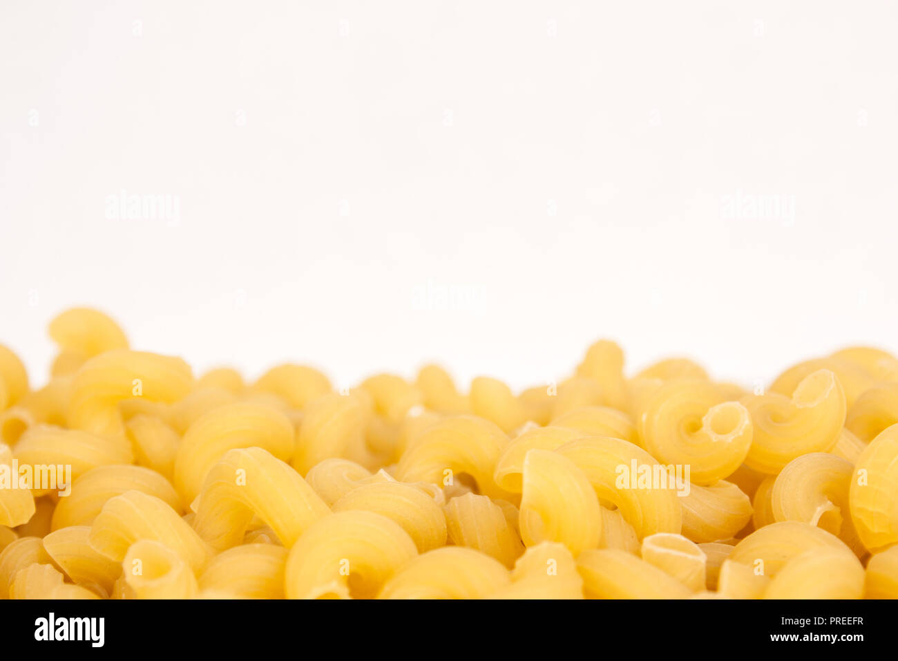Texture of amorini or pasta on a white background from above Stock ...