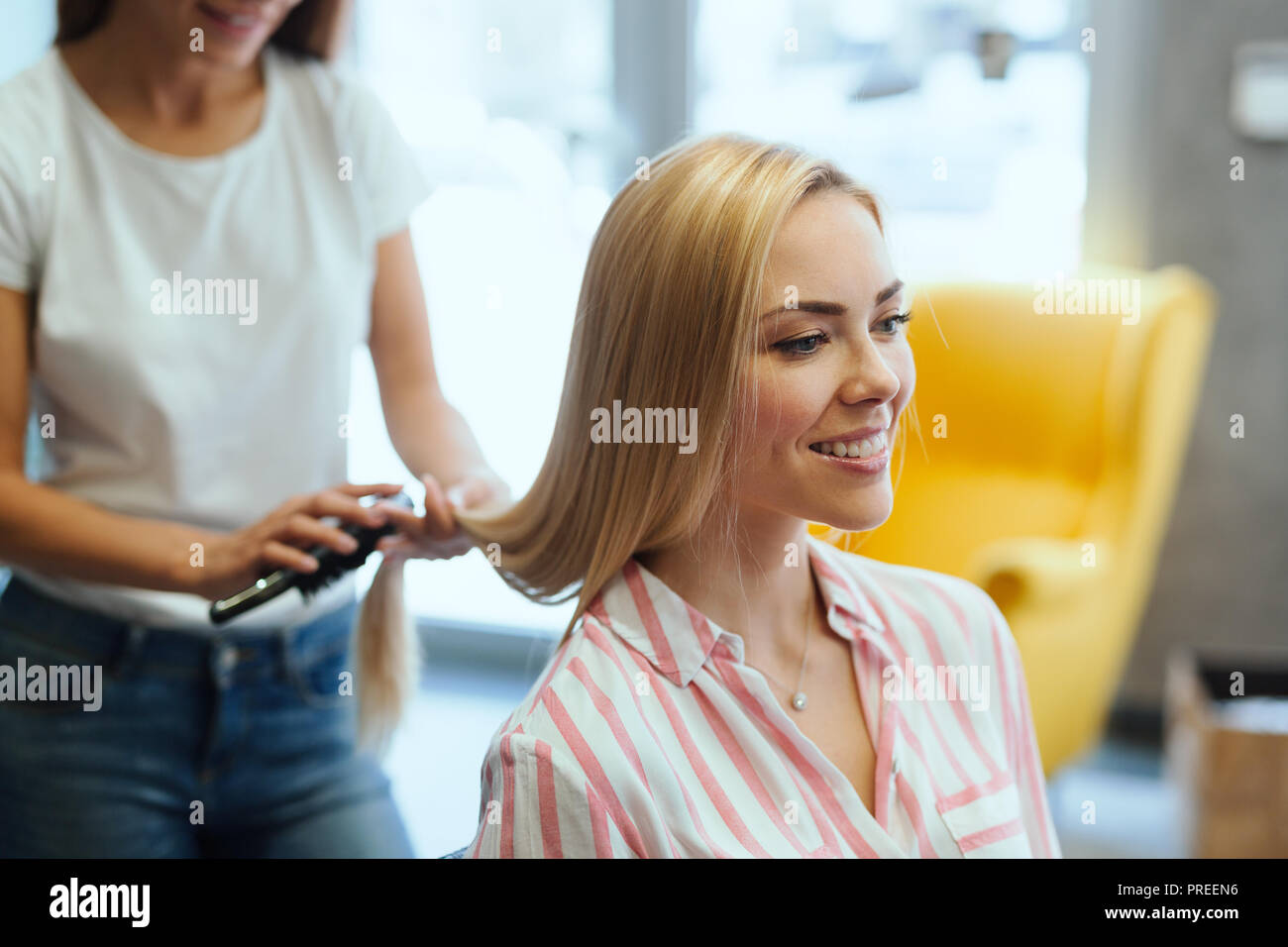 Hairdresser doing haircut for women in hairdressing salon Stock Photo ...