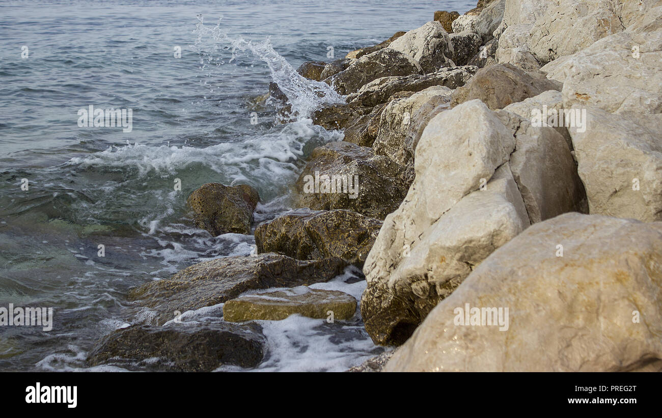 Surf waves of the sea in Croatia. Waves lap against the rocks and ...