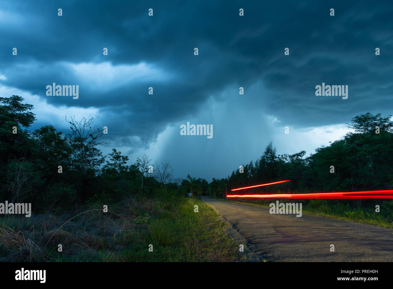 The road that leads to the falling rain from the thick Nimbus cloud ...