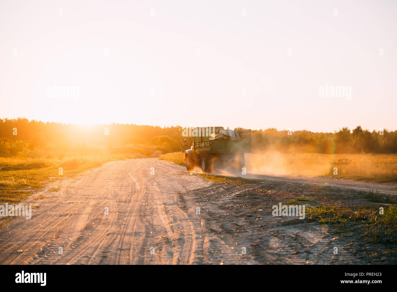 Truck Transporting Garbage On Country Sandy Road During Sunset Sunrise ...