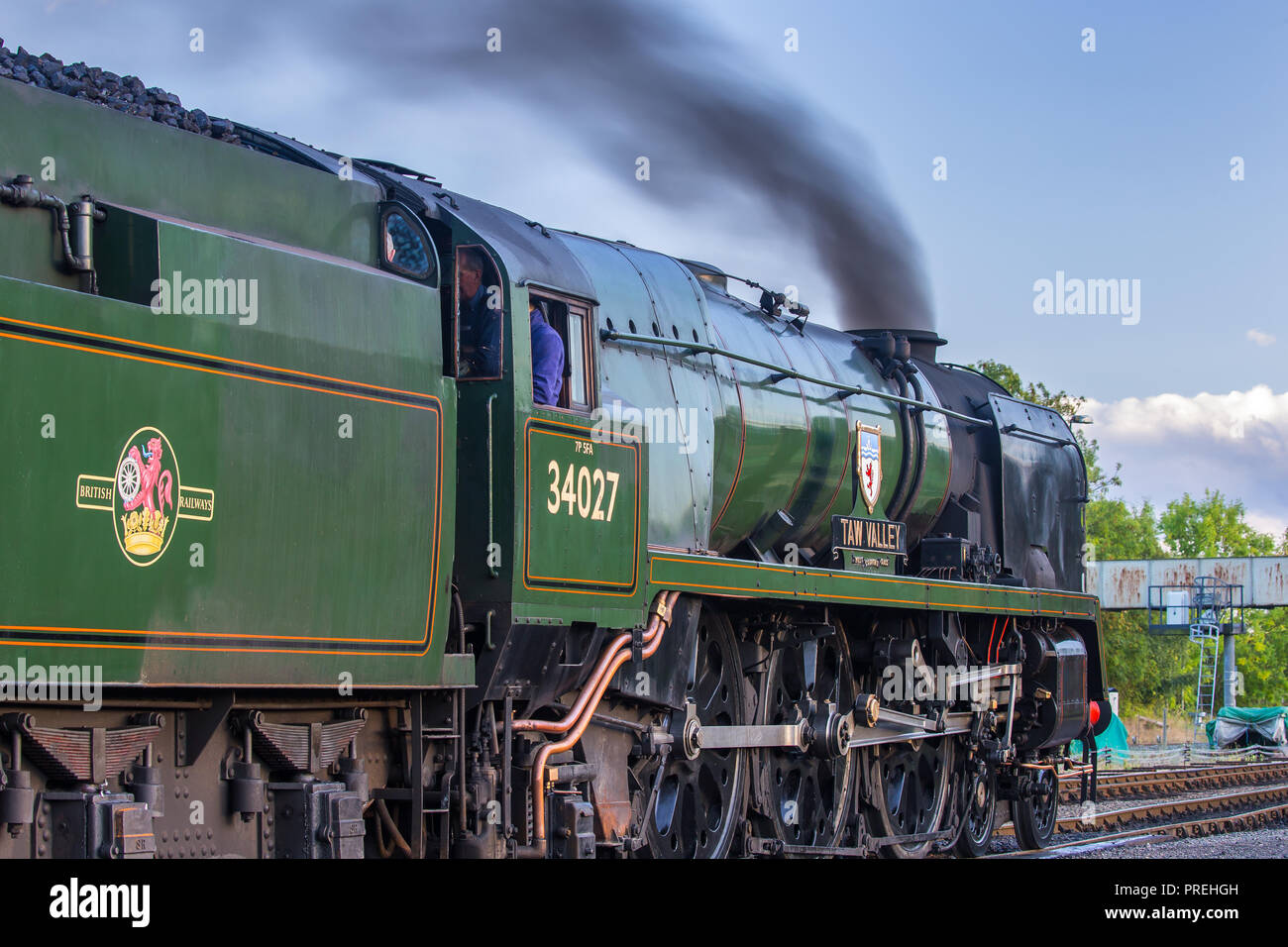 Close-up, side view of vintage UK steam locomotive & tender departing ...