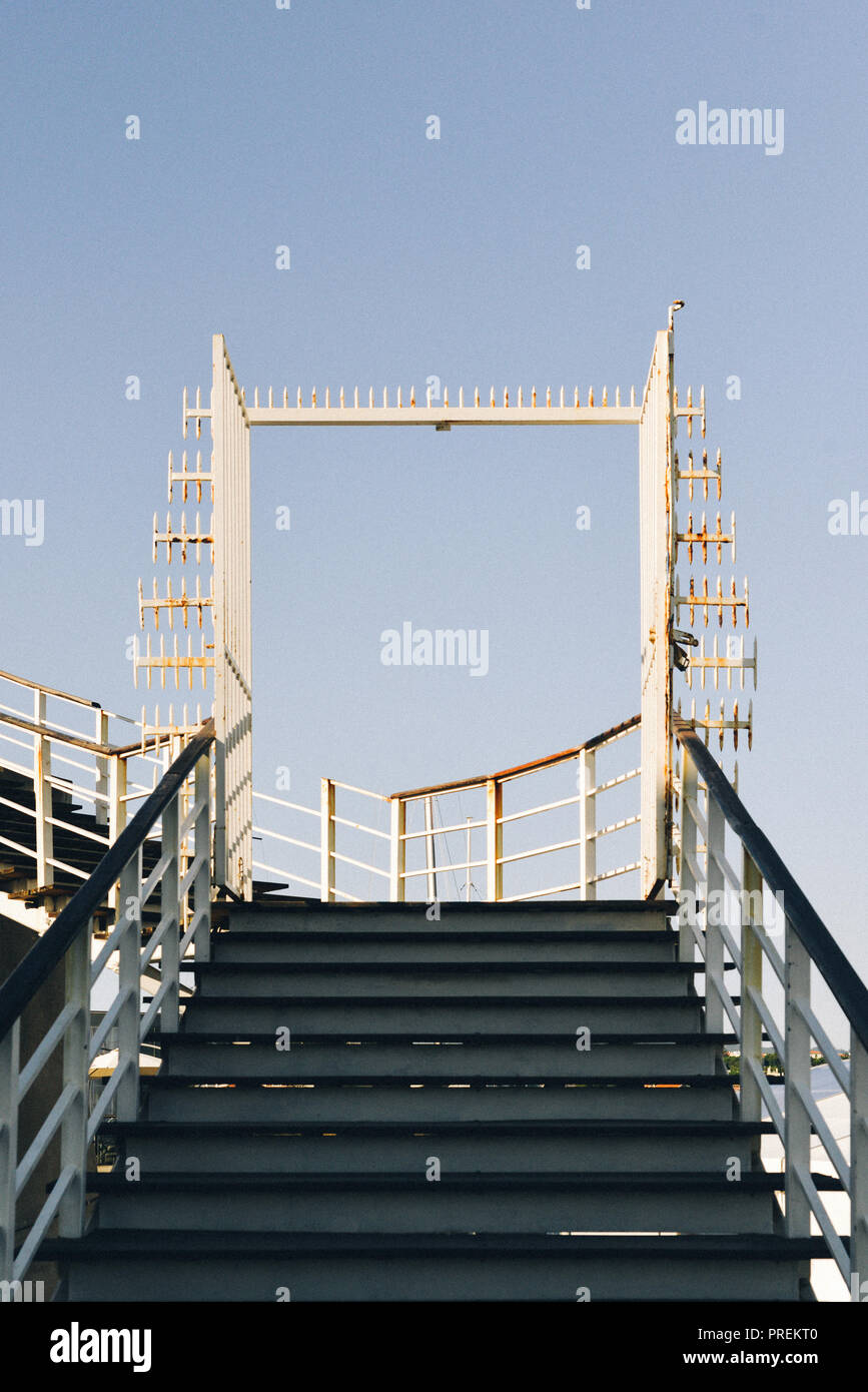 Stainless steel railing with gated entrance and blue sky - perfect for ...