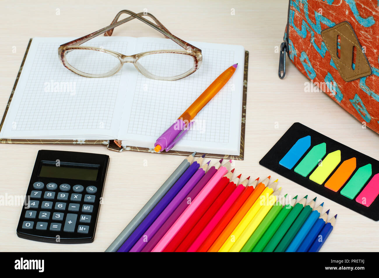 School supplies. School backpack, color pencils, notebook with glasses ...