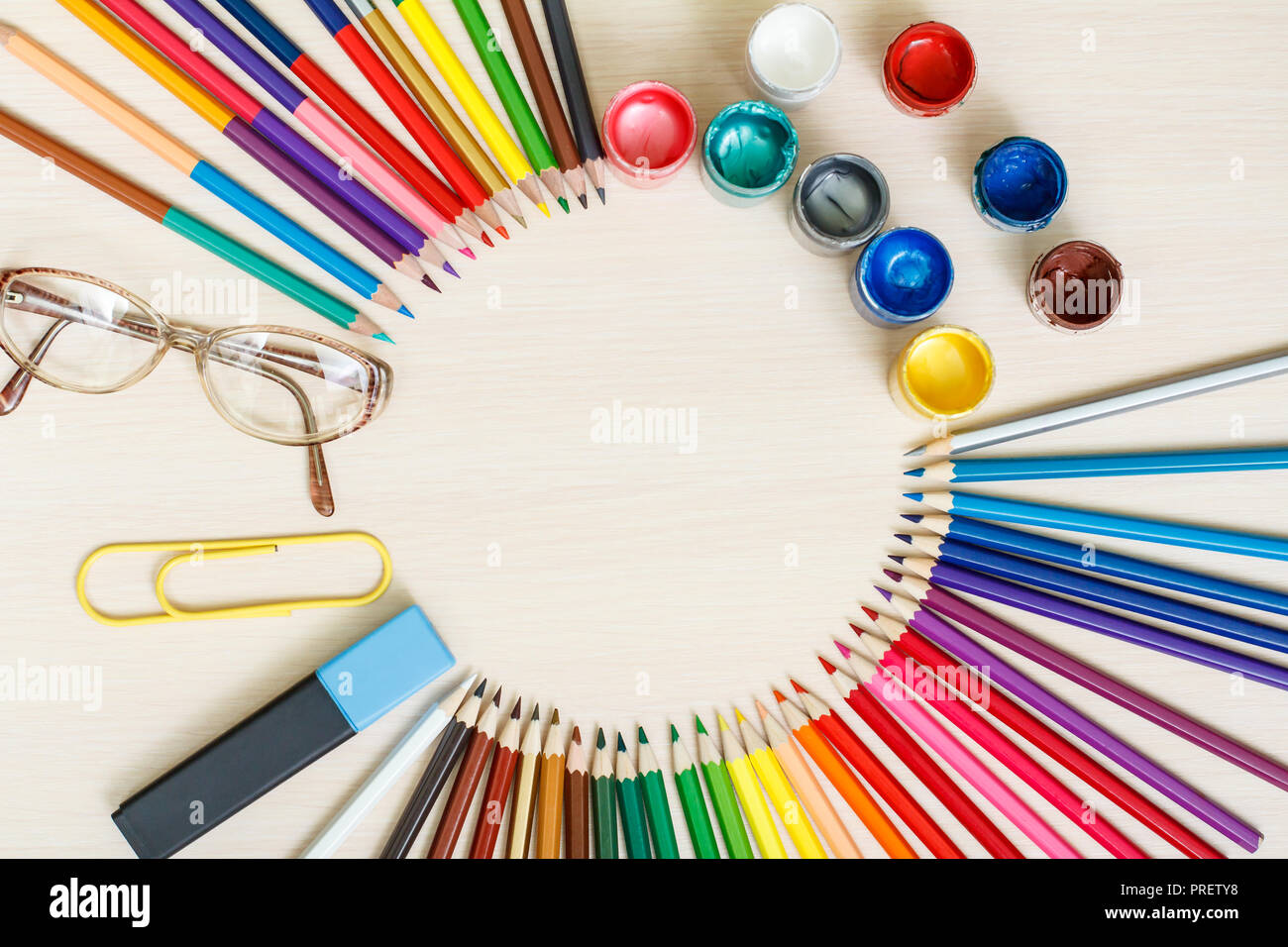 School supplies. Color pencils, glasses, big paper clip, marker and ...