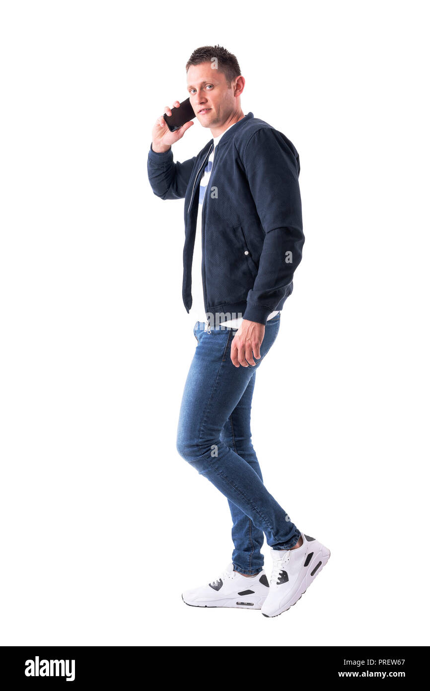 Cool relaxed confident man smiles at camera while talking on the ...