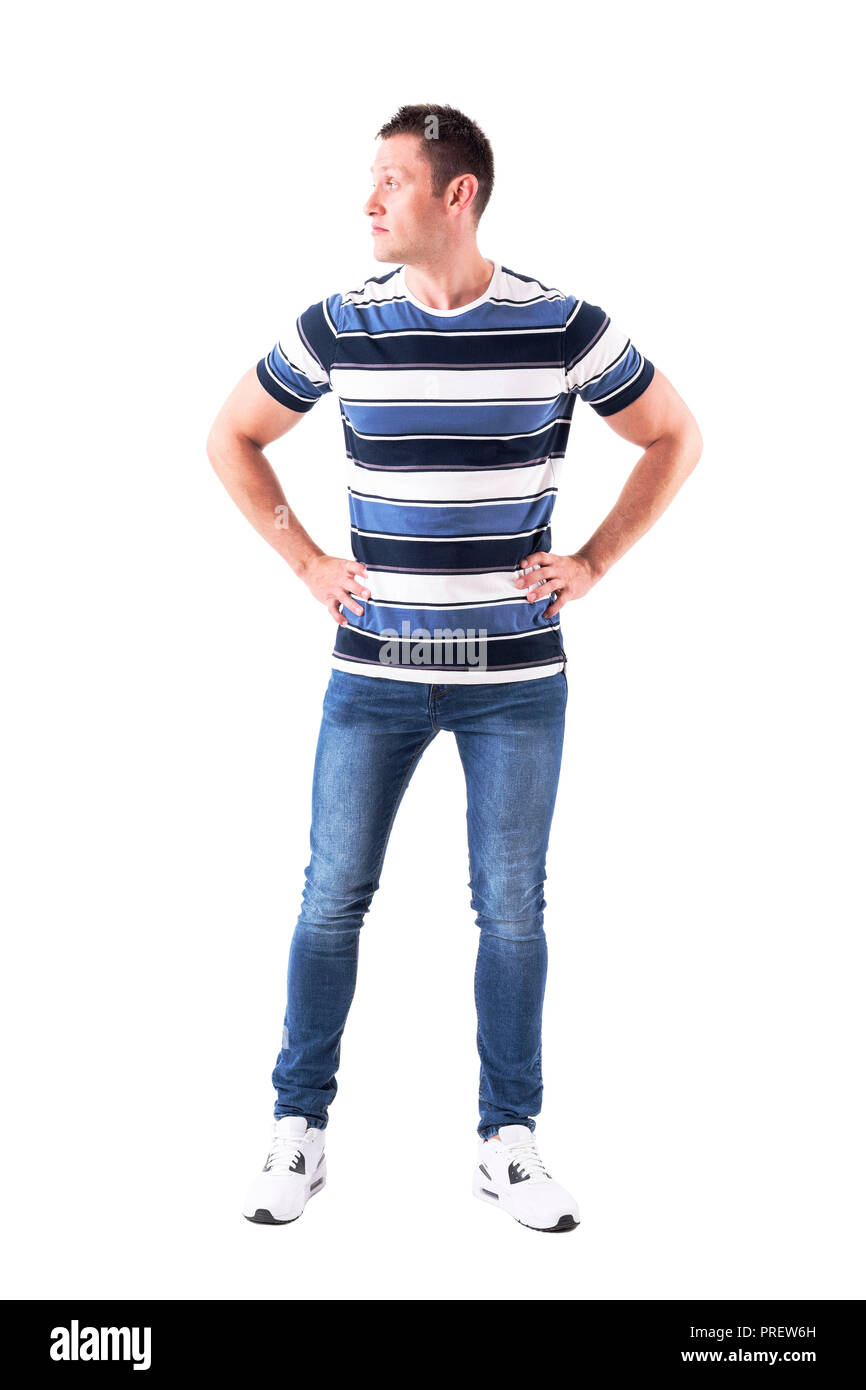 Serious masculine adult man with arms on hips looking away. Full body ...