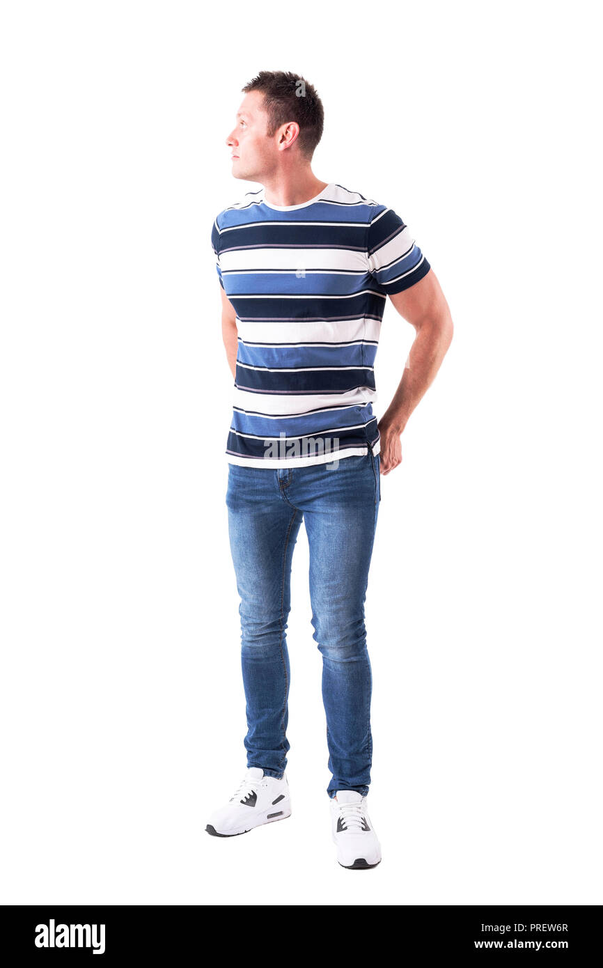 Young casual adult man with hands in back pockets looking up. Full body ...