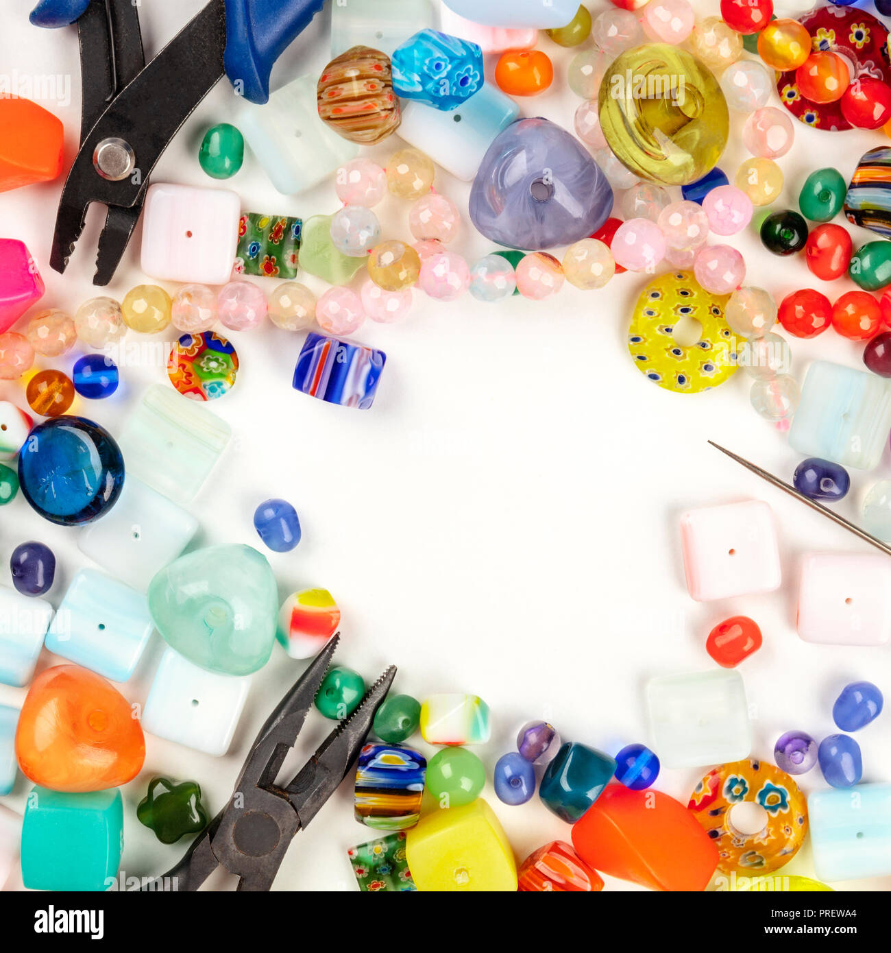 An overhead photo of many different beads with instruments for making ...