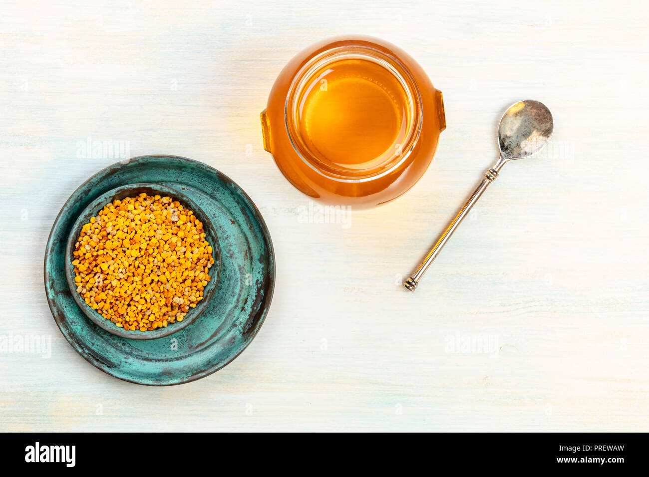 Healthy organic food. An overhead photo of pollen, a jar of honey, and ...