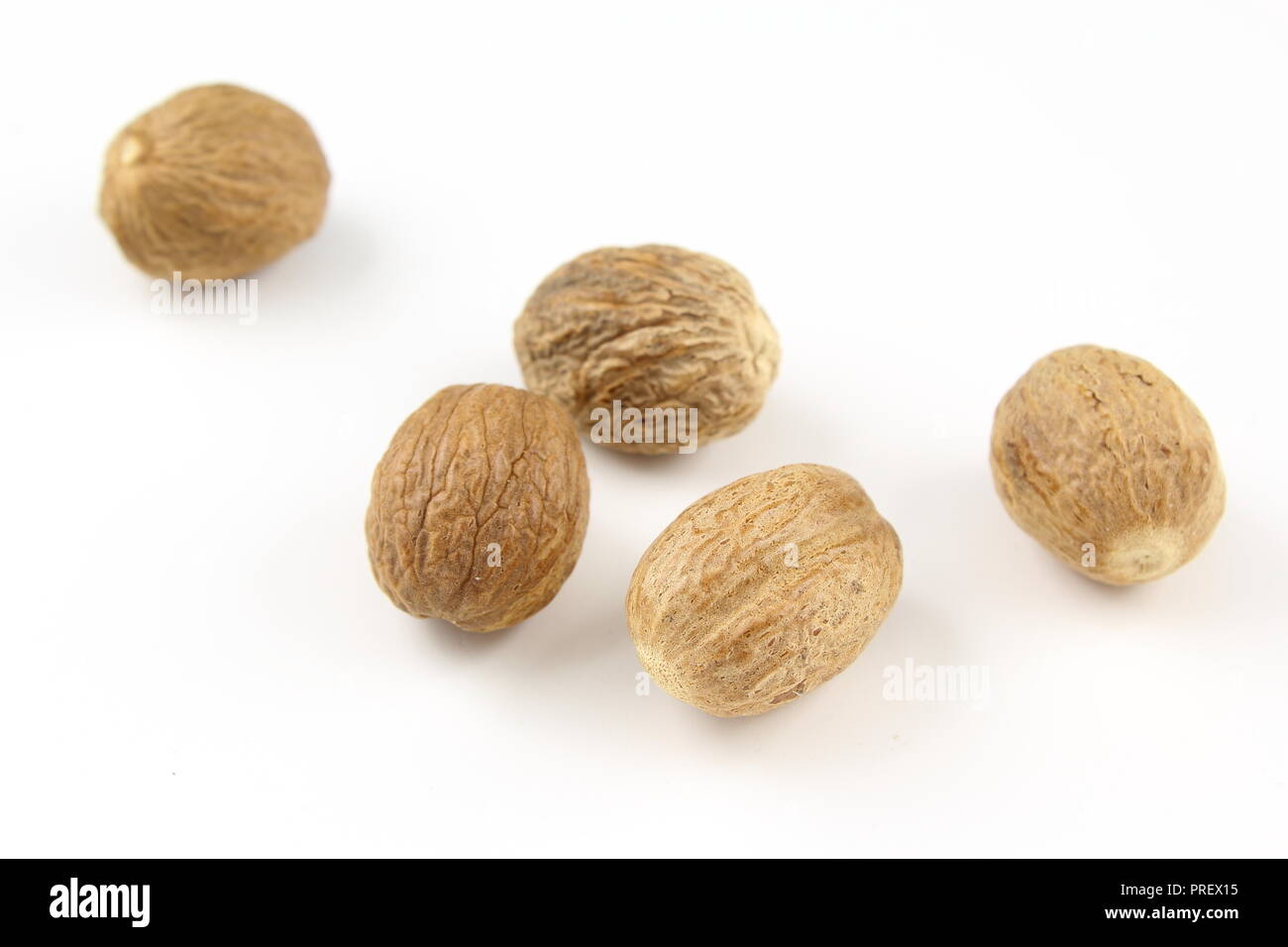 composition of nutmeg seeds isolated on a white background Stock Photo ...
