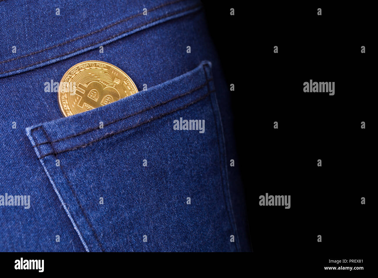 gold bitcoin in the back pocket of jeans, background image with space ...