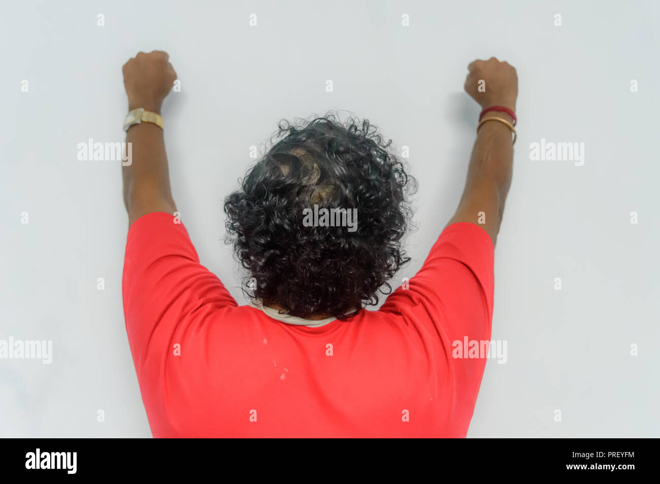 Studio shot of modern hipster old man with hands up, back view ...