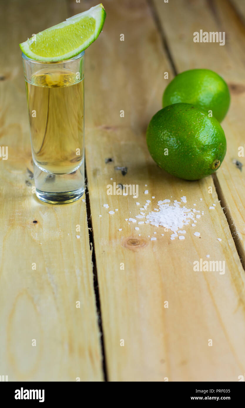 Mexican Gold Tequila with lime and salt on wooden table. Copyspace for ...