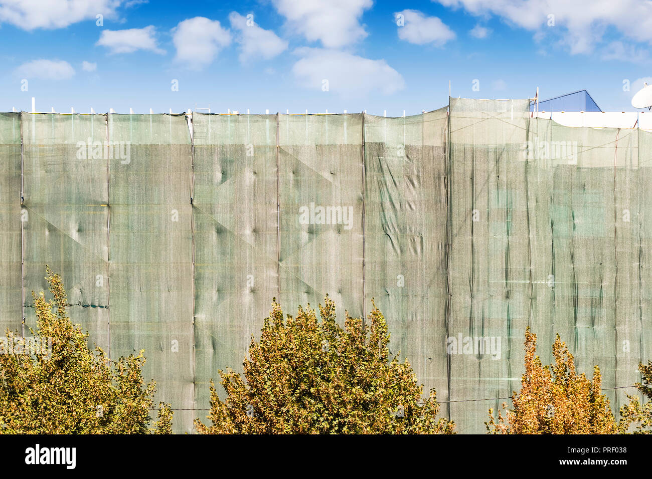 Reconstruction of the building in the city, protected by a large canvas ...