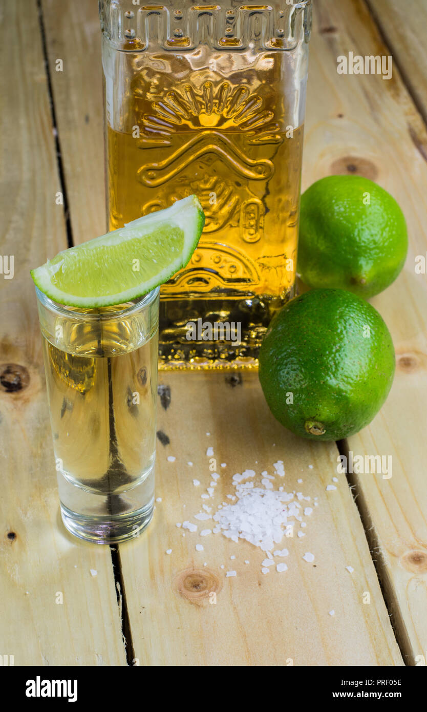 Mexican Gold Tequila with lime and salt on wooden table. Copyspace for ...