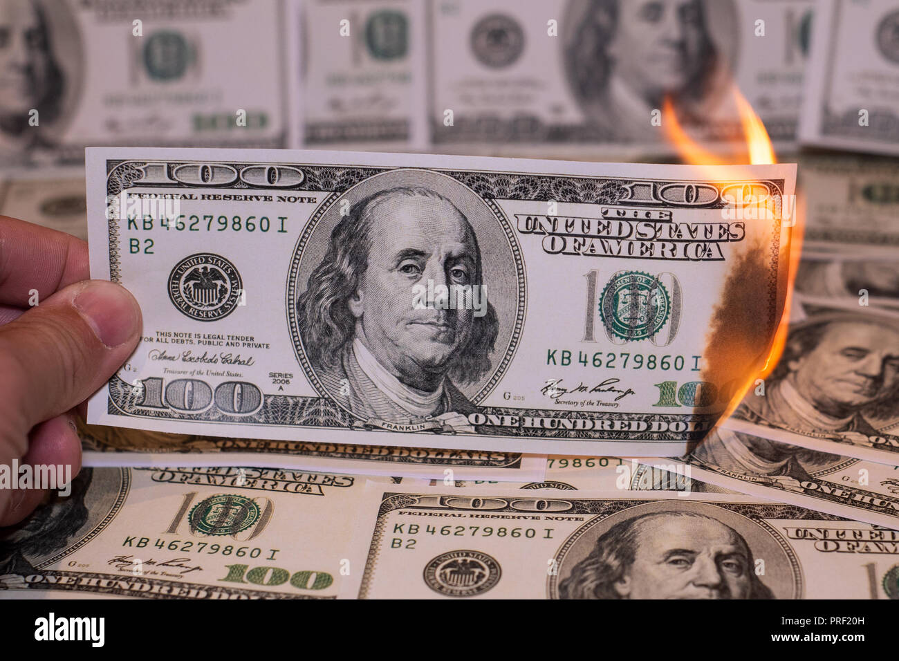 A hunred dollar bill in American US currency is on fire Stock Photo - Alamy