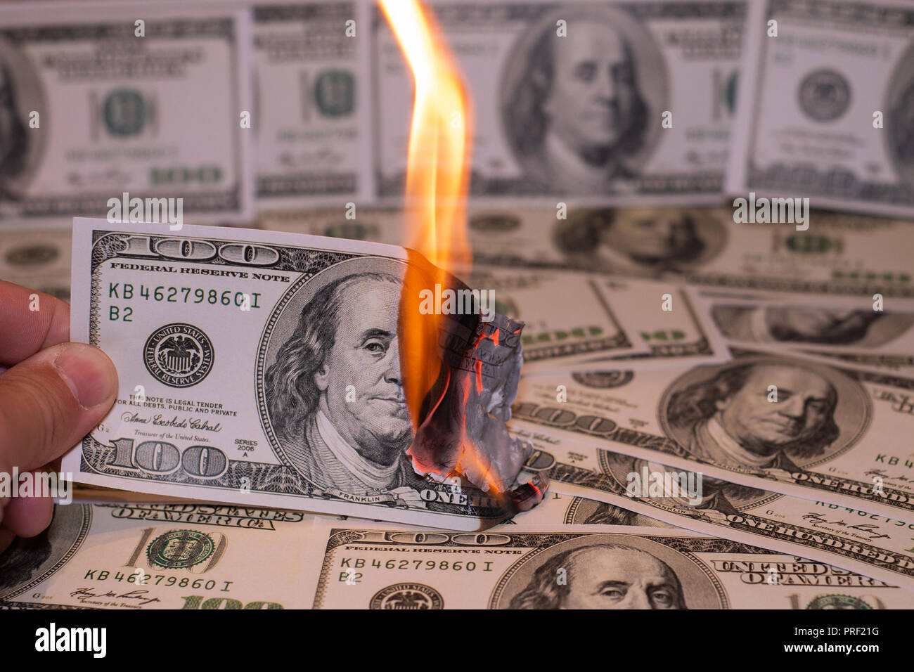 Burning one hundred dollar bill hi-res stock photography and images - Alamy