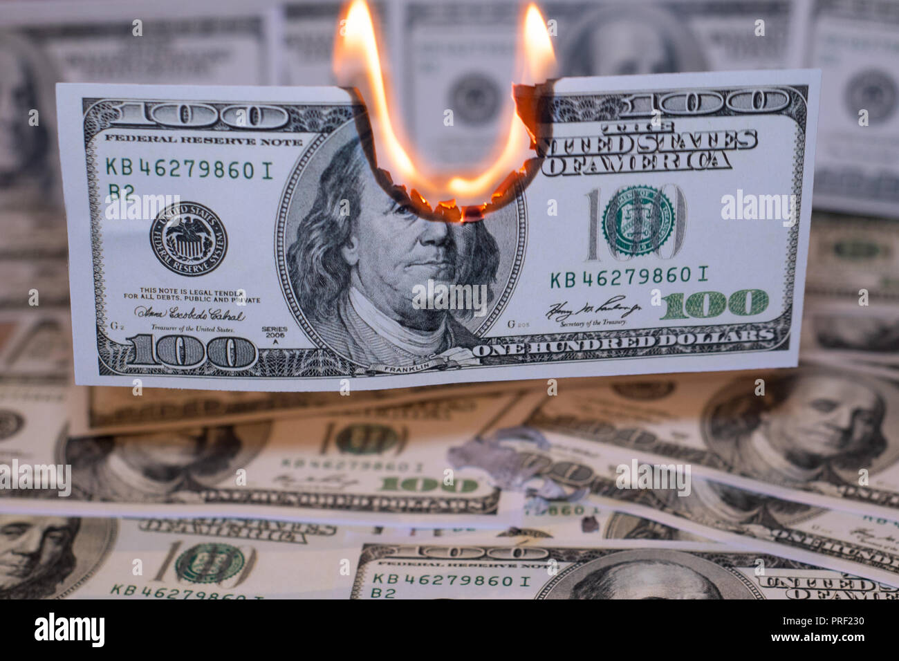 A hunred dollar bill in American US currency is on fire Stock Photo - Alamy