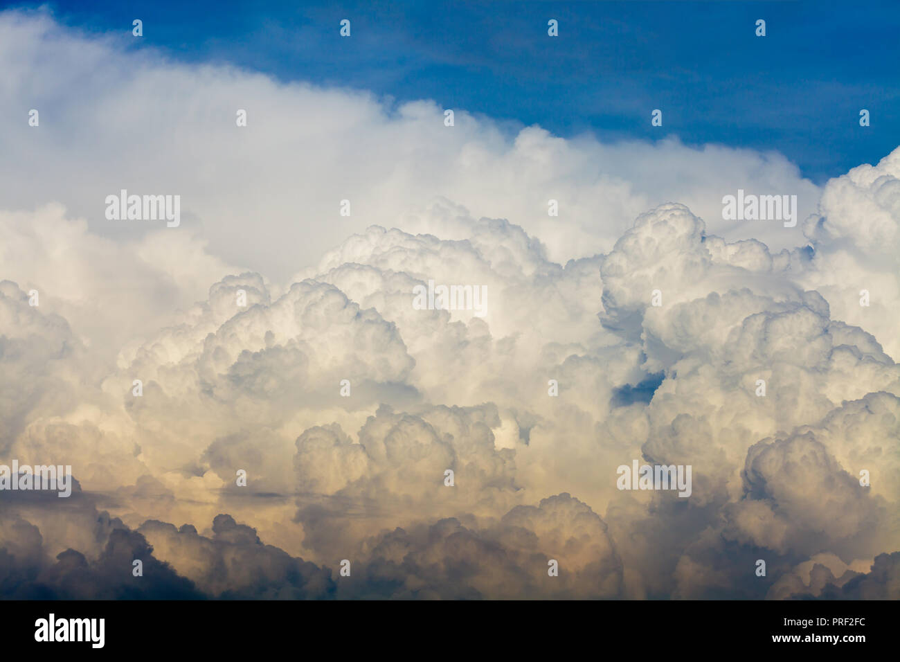 Cumulonimbus clouds against blue sky Stock Photo - Alamy