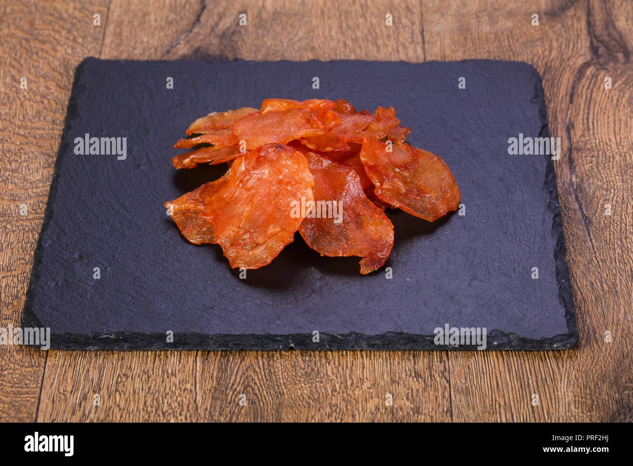 Dry chicken meat over wooden Stock Photo - Alamy