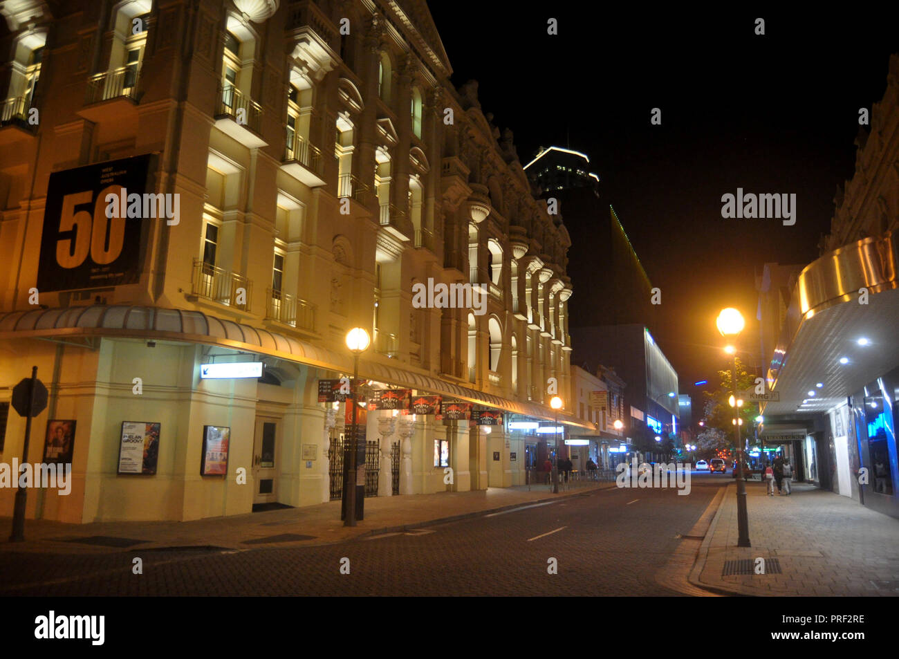 Australian people walking on pavement beside road with classic building ...