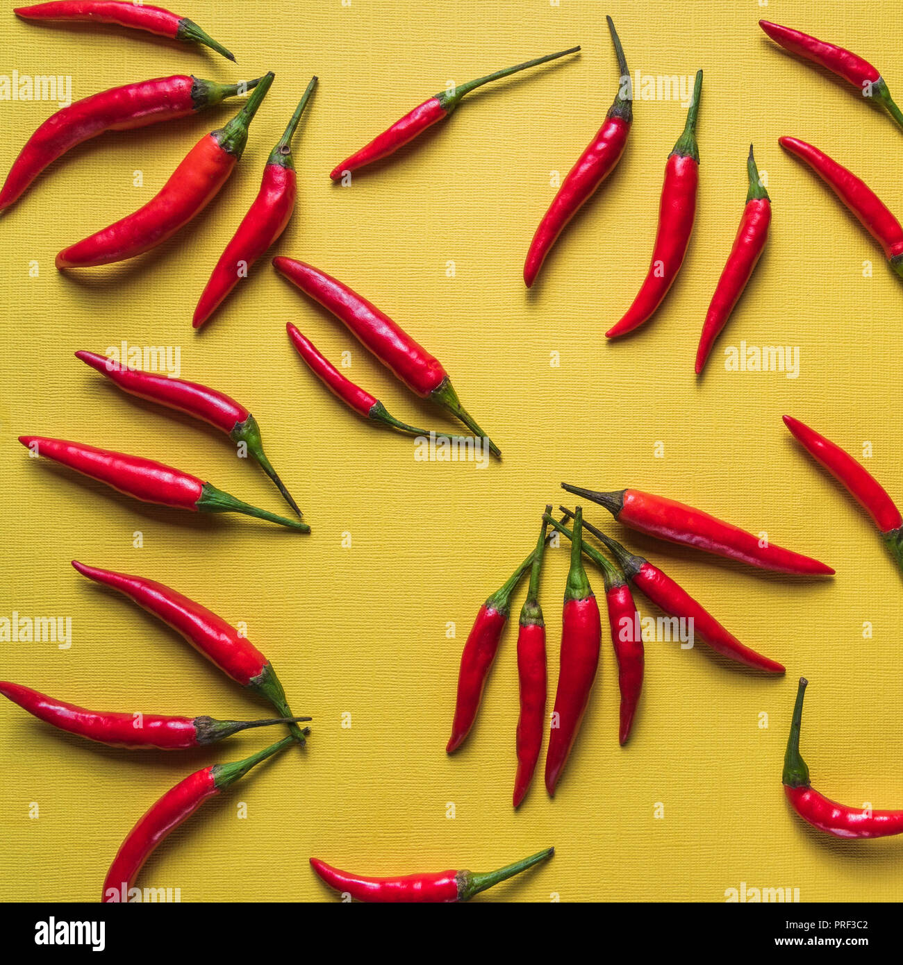 Abstract Food background with ripe red chili peppers, on yellow ...