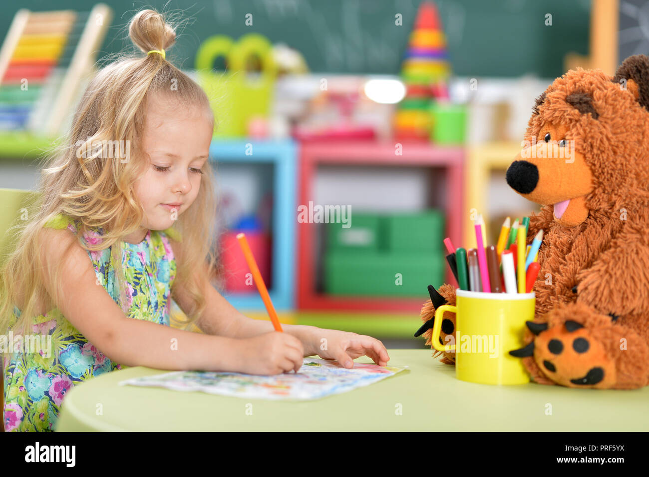 cute beautiful little girl drawing at table Stock Photo - Alamy