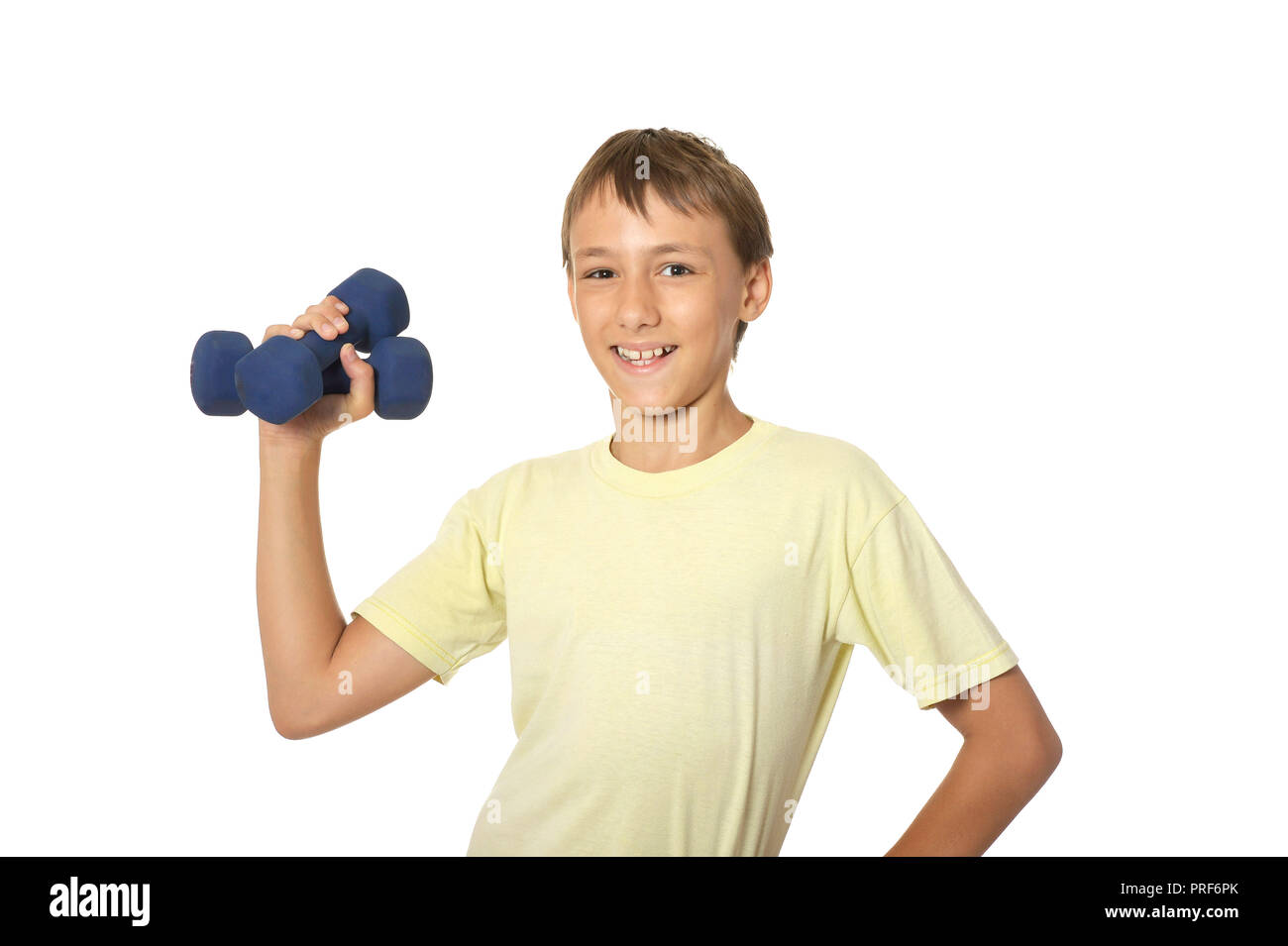 Young boy doing exercises with dumbbells isolated on white background ...