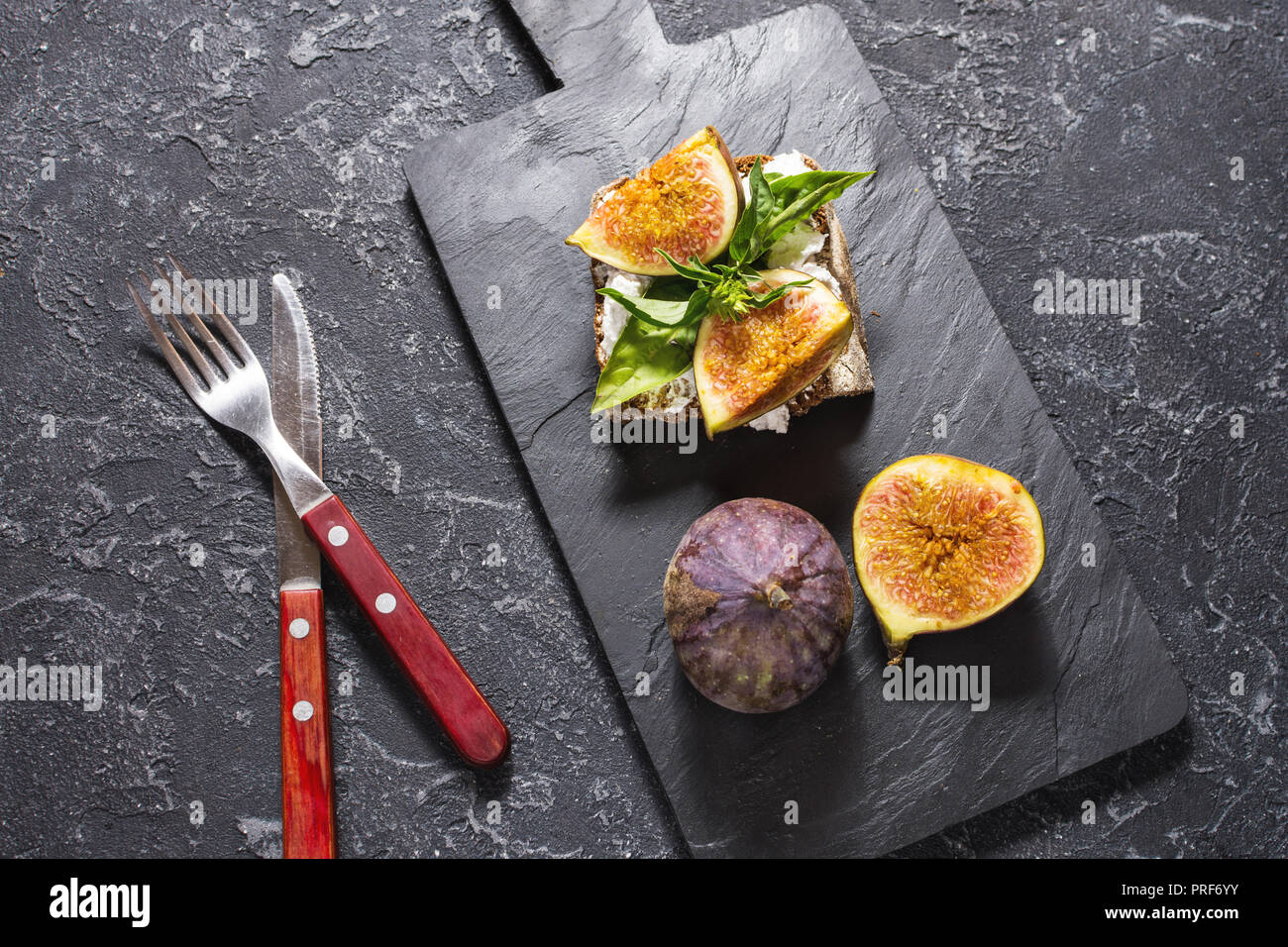 Figs fruit sandwich on a slate plate on a black stone background Stock ...