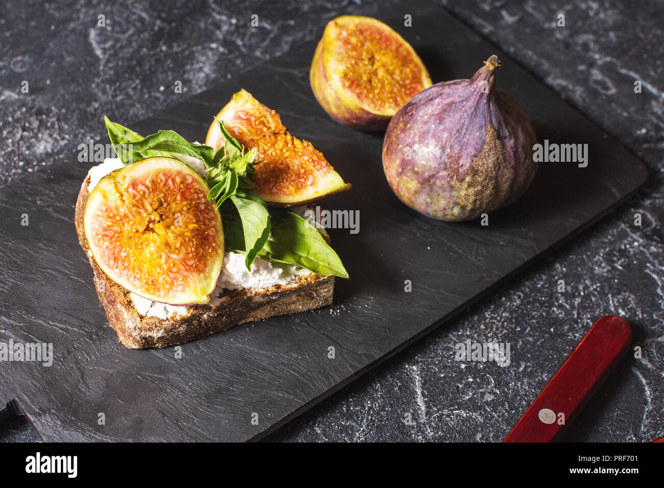 Figs fruit sandwich on a slate plate on a black stone background Stock ...