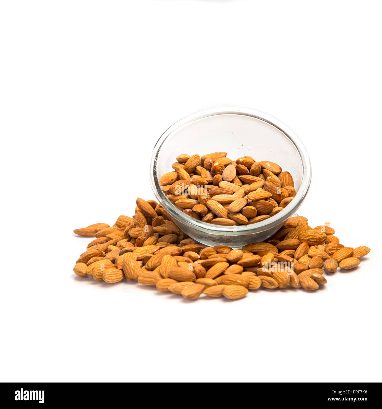 Almond heap, almond bowl isolated on white background Stock Photo - Alamy
