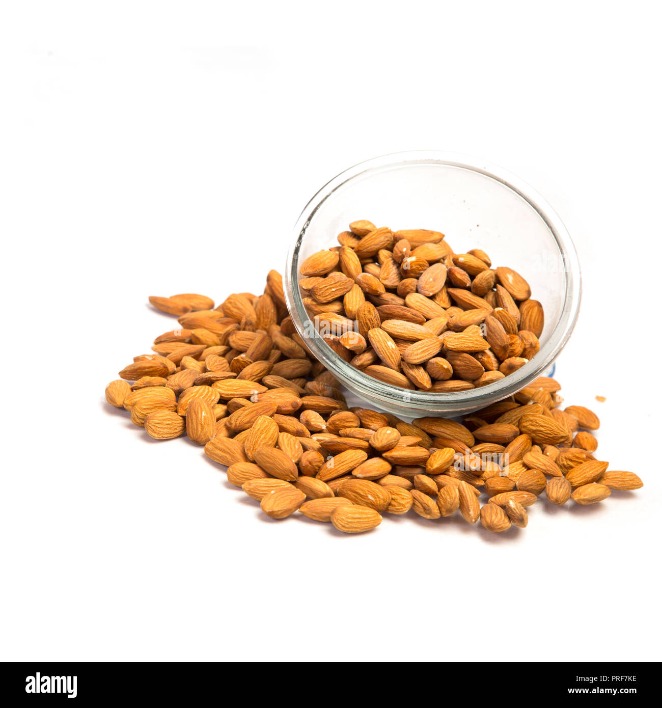 Almond heap, almond bowl isolated on white background Stock Photo - Alamy