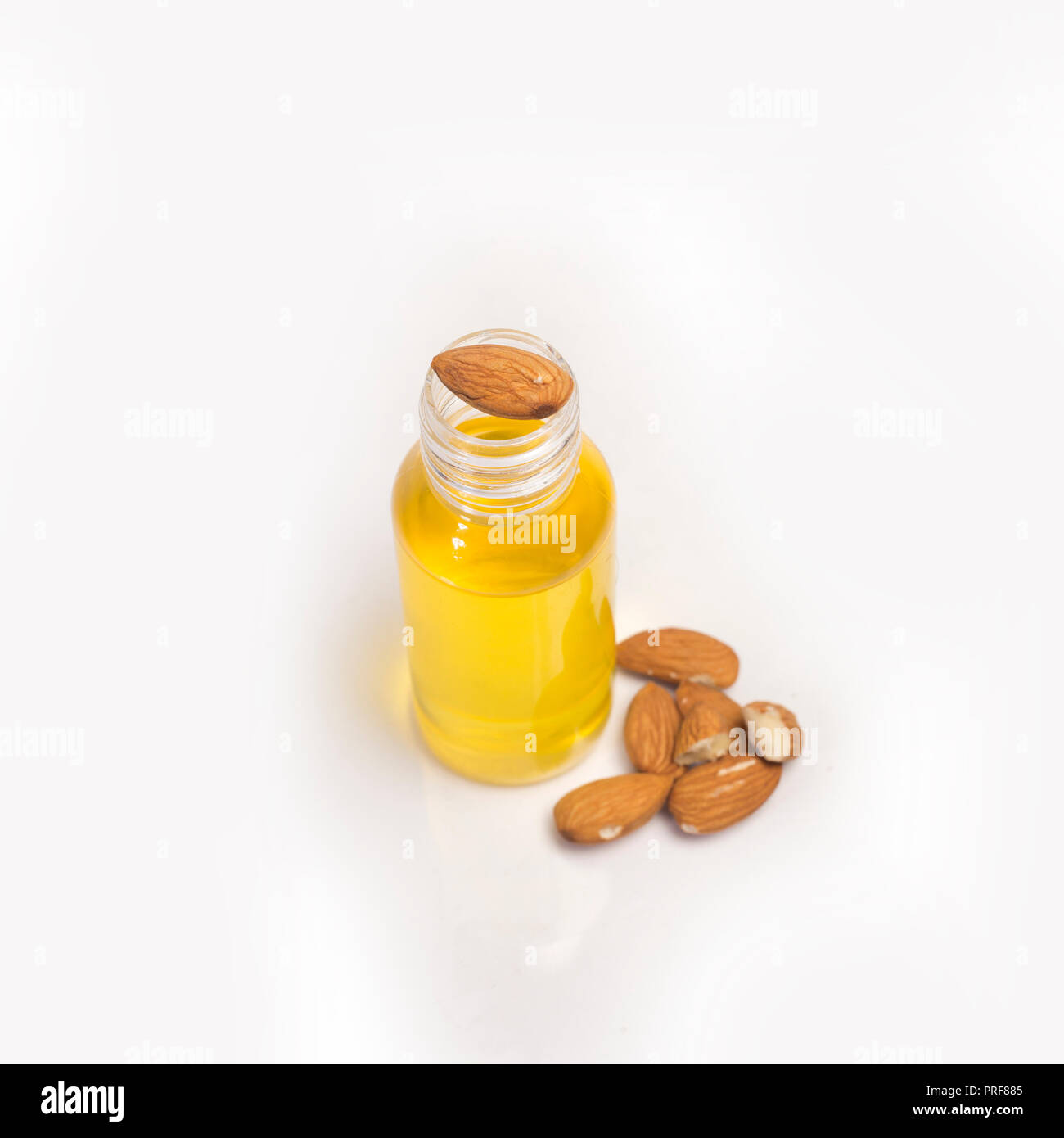 Almond, oil or roghan isolated on white background Stock Photo - Alamy