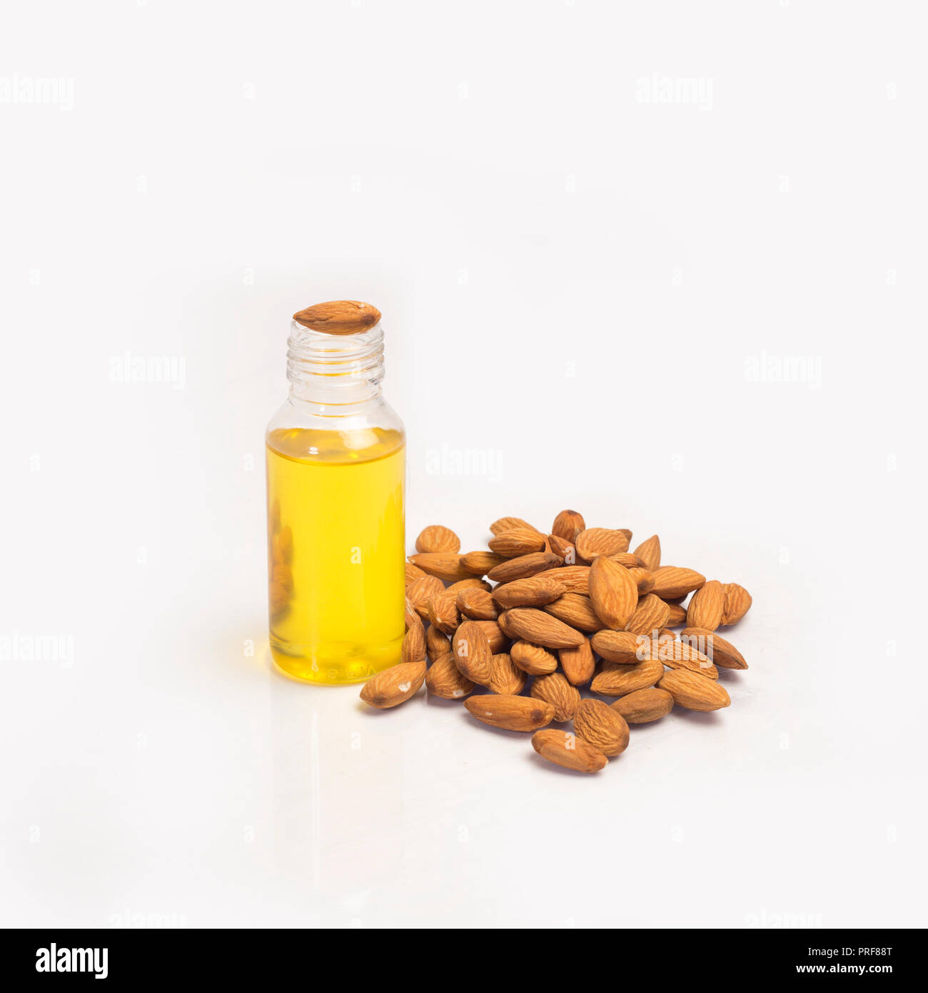 Almond oil/roghan, almond nut heap isolated on white background Stock ...