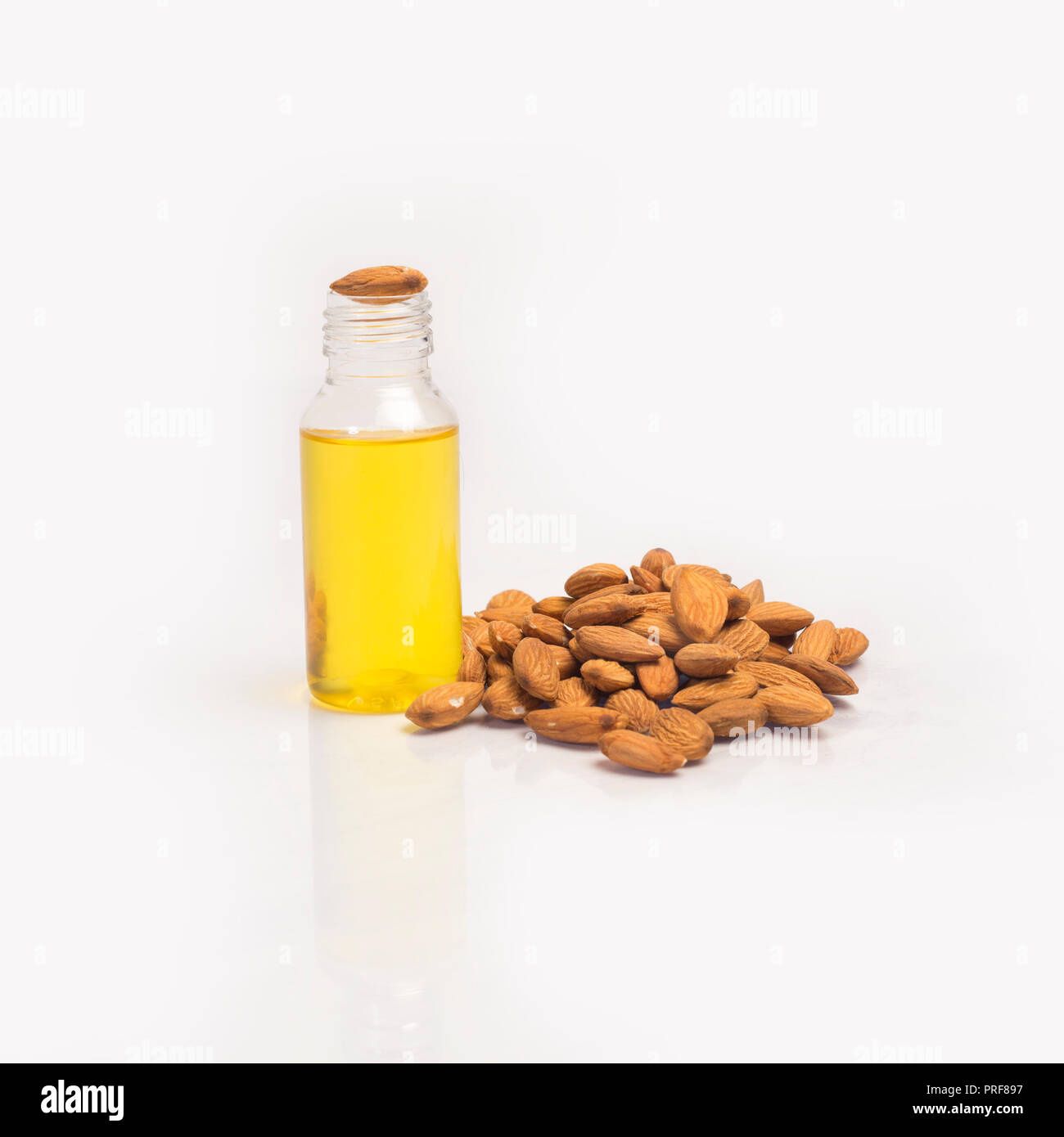 Almond oil/roghan, almond nut heap isolated on white background Stock ...