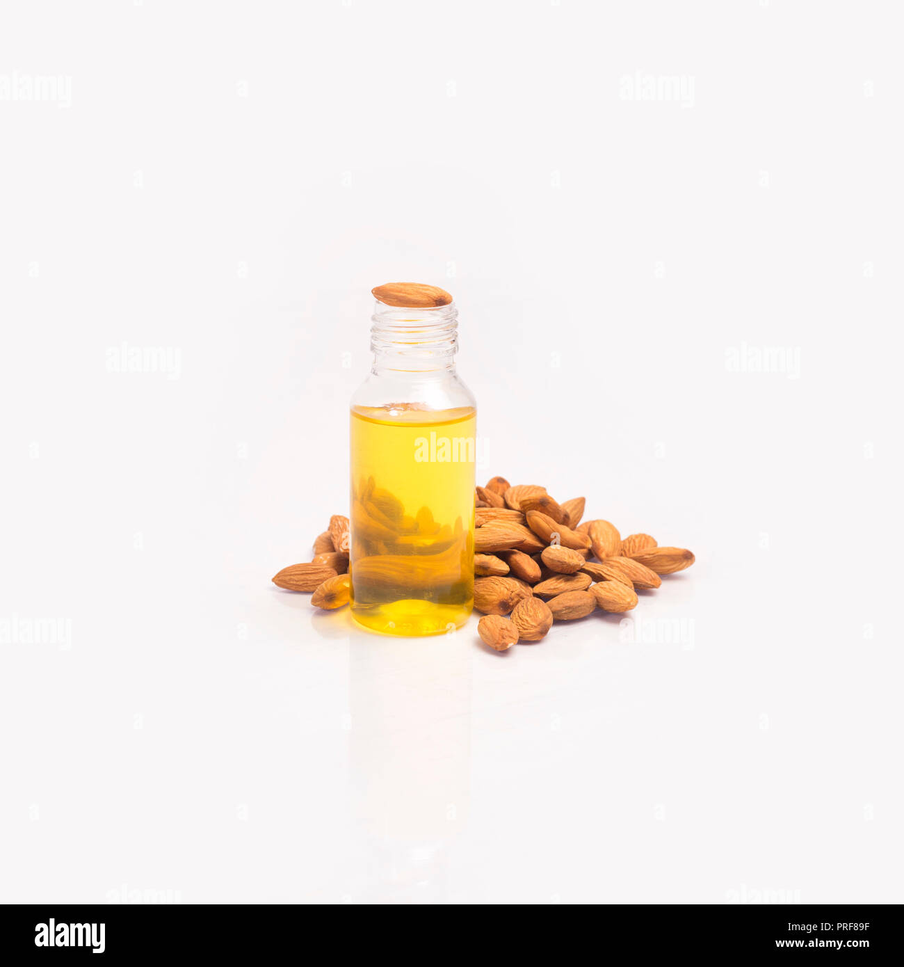 Almond oil/roghan, almond nut heap isolated on white background Stock ...
