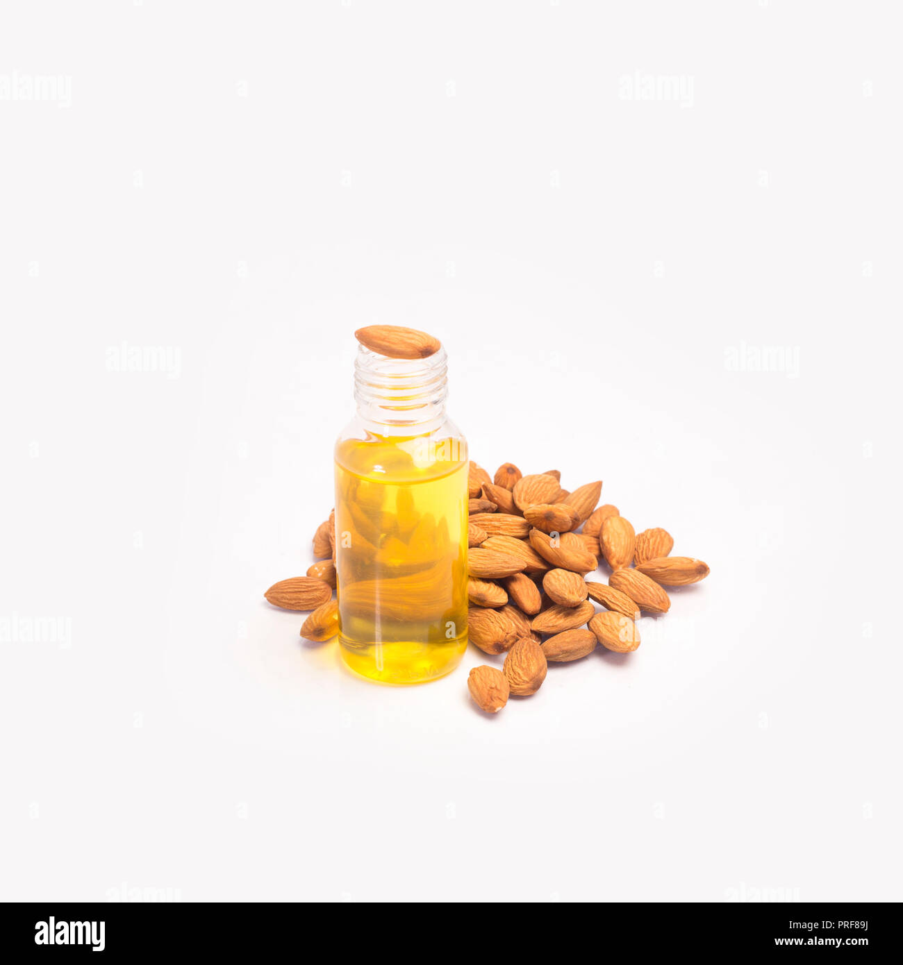 Almond oil/roghan, almond nut heap isolated on white background Stock ...