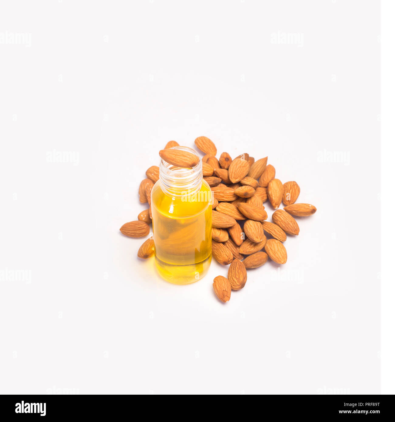 Almond oil/ roghan, almond nut heap isolated on white background Stock ...