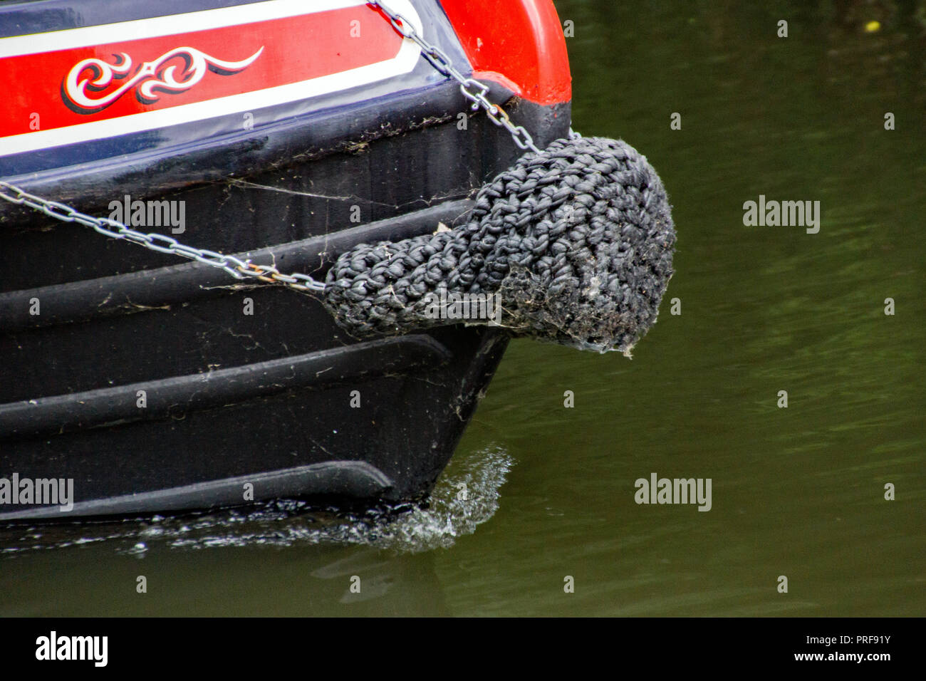 A canal boat and bow wave heading south on the River Stort part of the ...