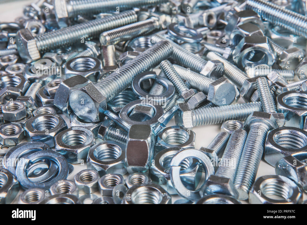 chromeplated bolts and nuts on white background Stock Photo - Alamy