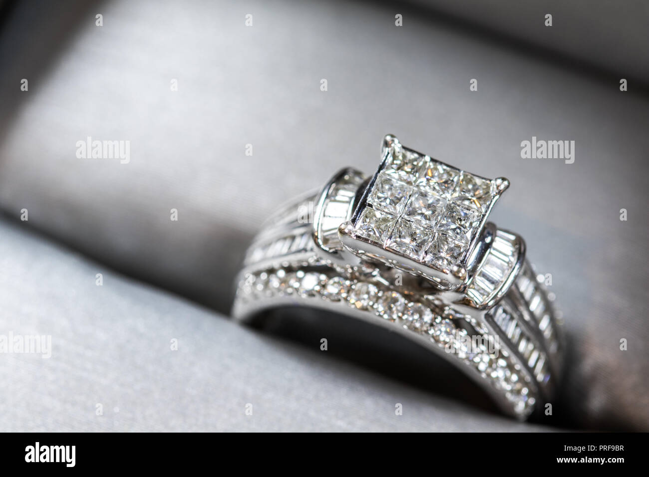A diamond engagement ring in a box with glint/reflection. Shimmering ...