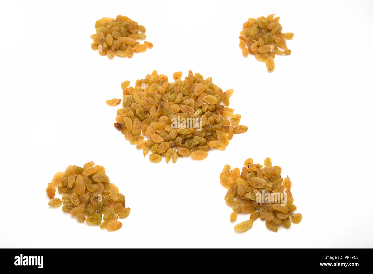 Different Raisins heap isolated on white background Stock Photo - Alamy