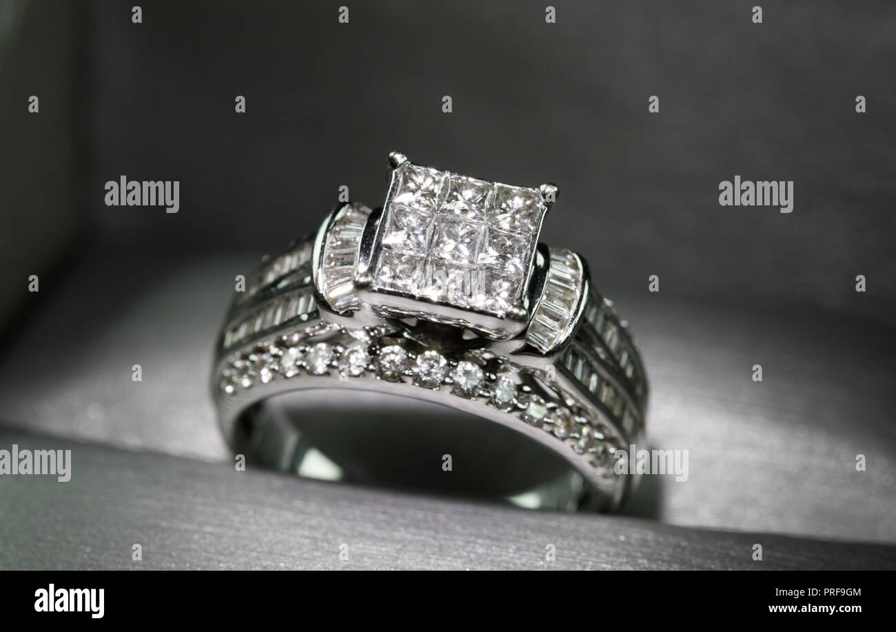 A diamond engagement ring in a box with glint/reflection. Shimmering ...