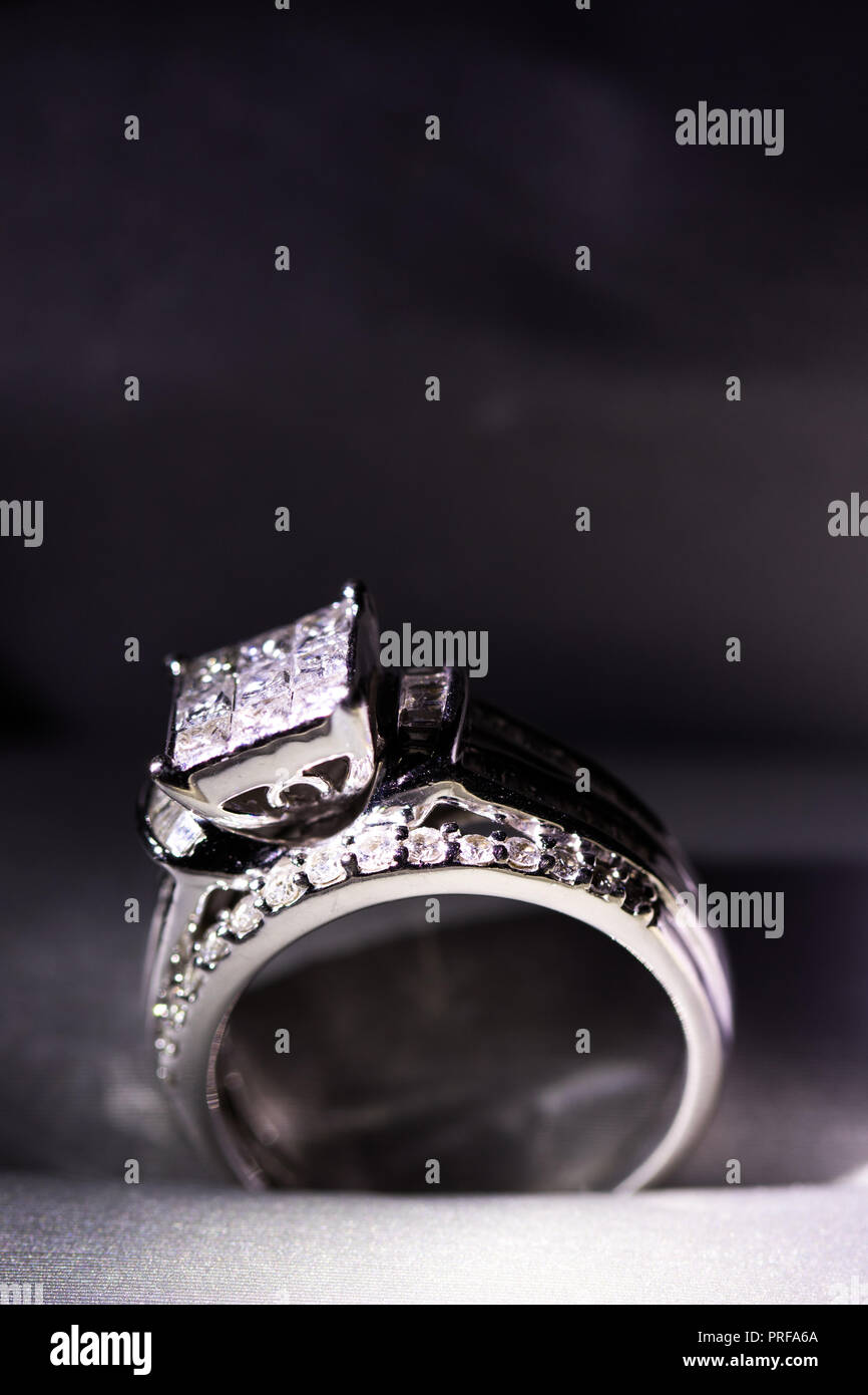 A diamond engagement ring in a box with glint/reflection. Shimmering ...