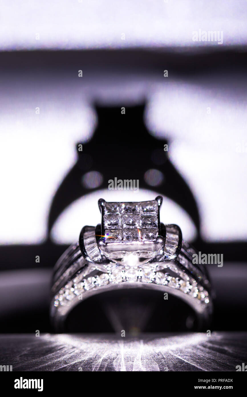 A diamond engagement ring in a box with glint/reflection. Shimmering ...