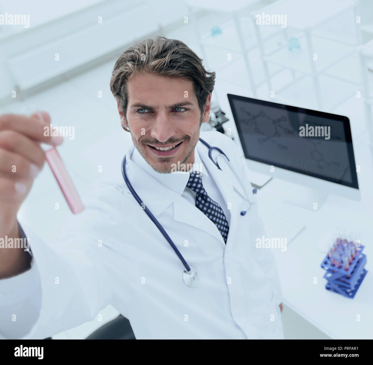 Man in laboratory checking test tubes Stock Photo - Alamy