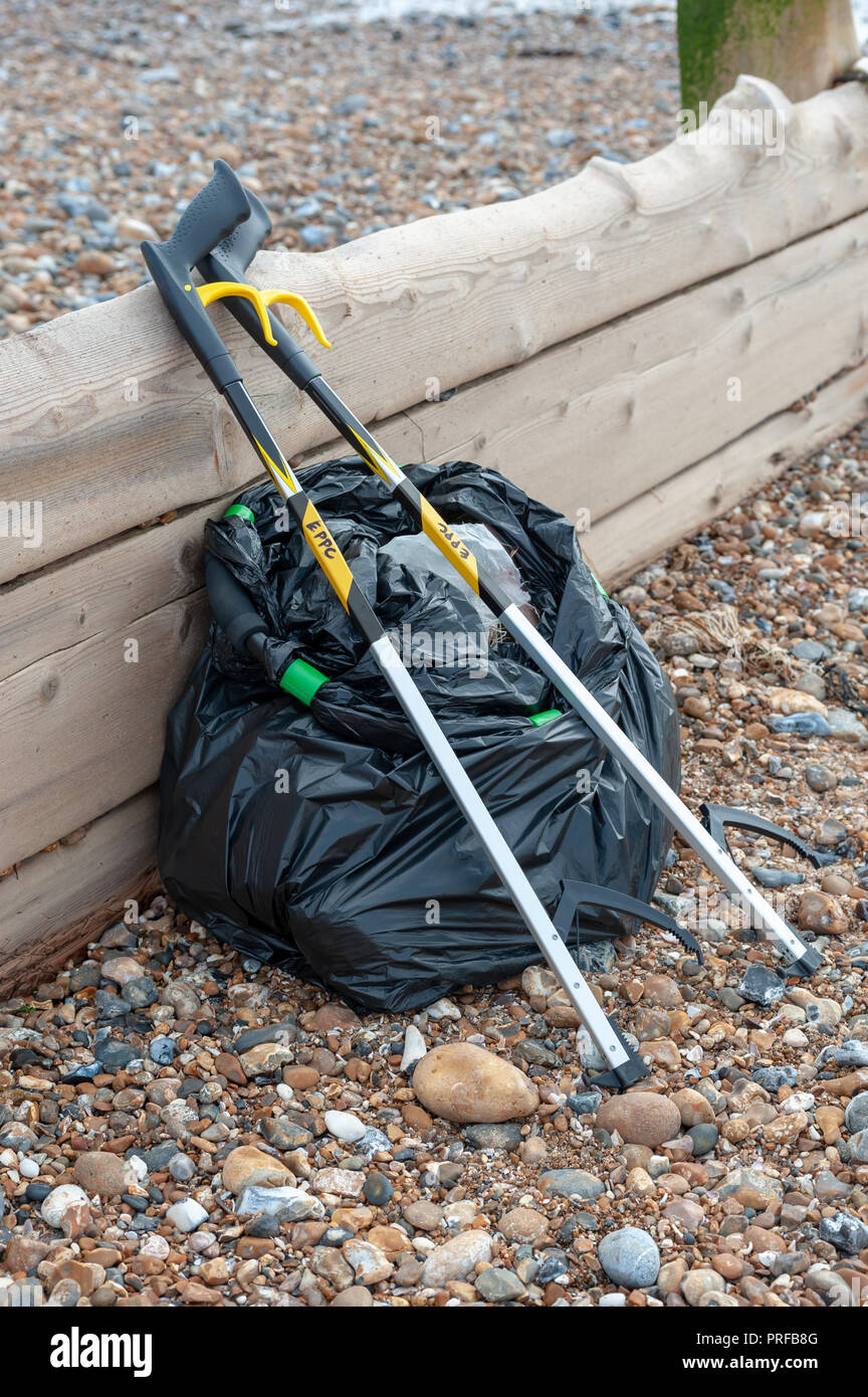 Beach clean up. A black bag full of rubbish collected from the beach ...