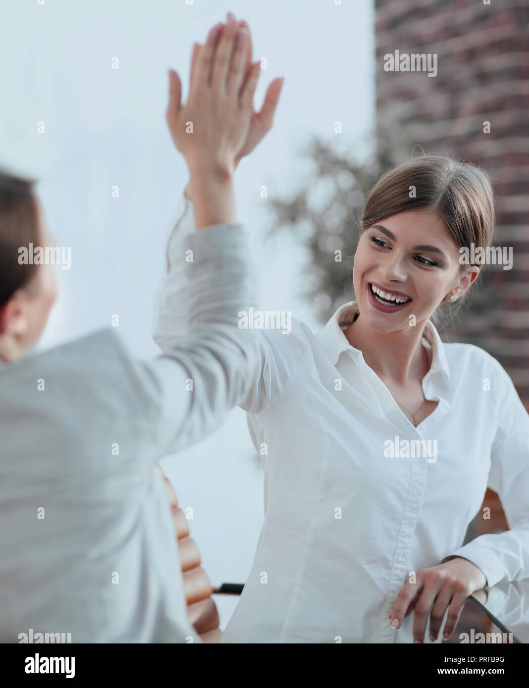 members of the business team giving each other a high five Stock Photo ...