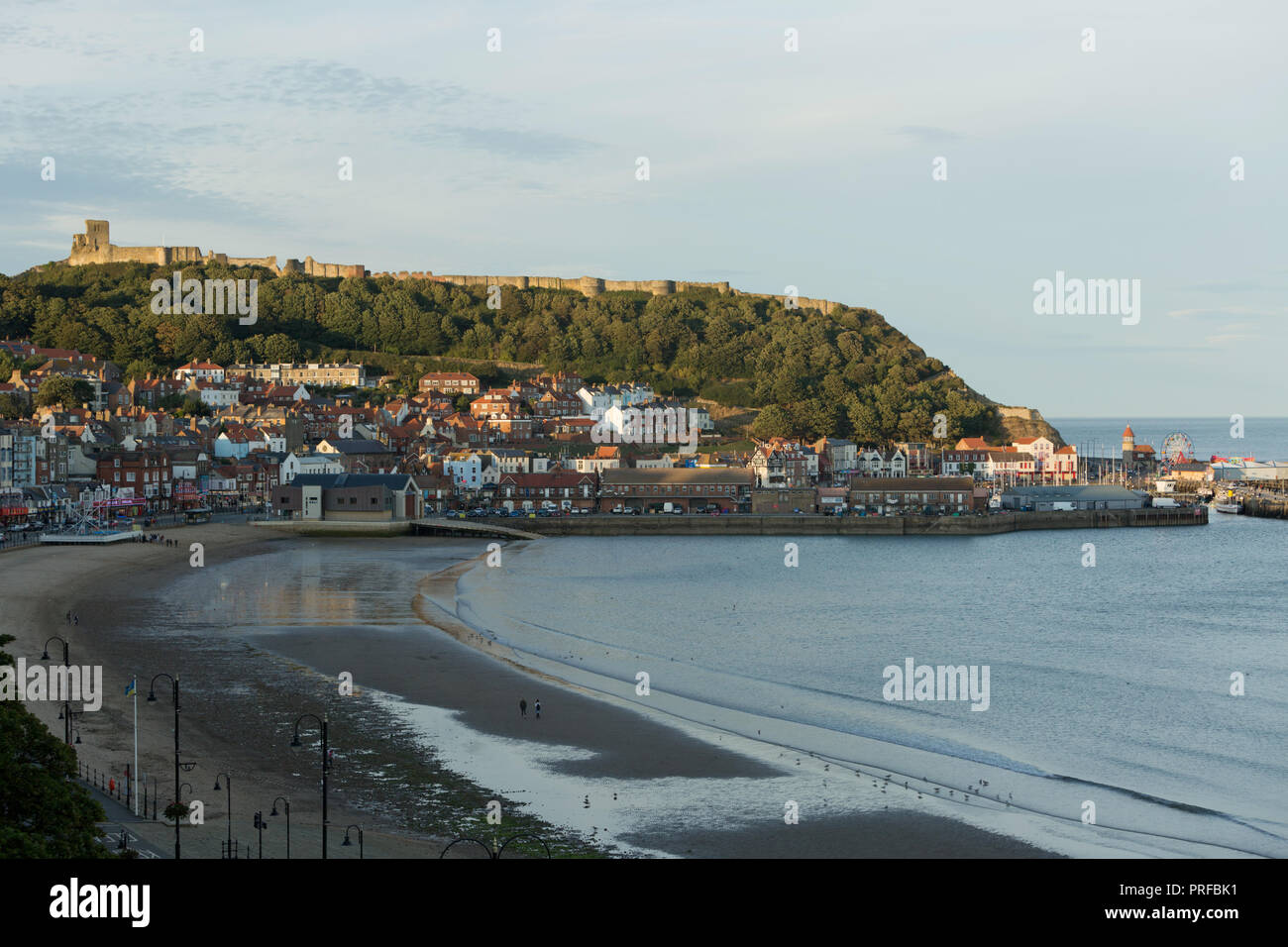 Scarborough beach with Scarborough Castle, harbour and lighthouse ...
